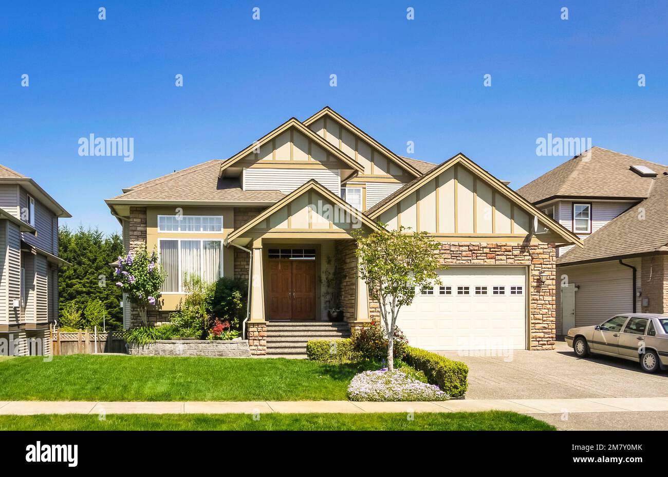 Luxury family house with car parked on concrete driveway Stock Photo ...