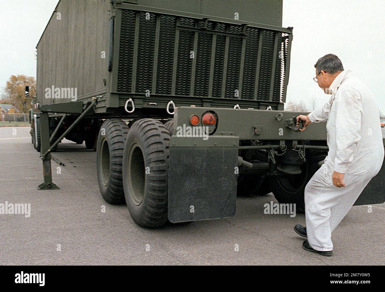 The dolly assembly is removed from underneath the XM-971E1 semi-trailer ...