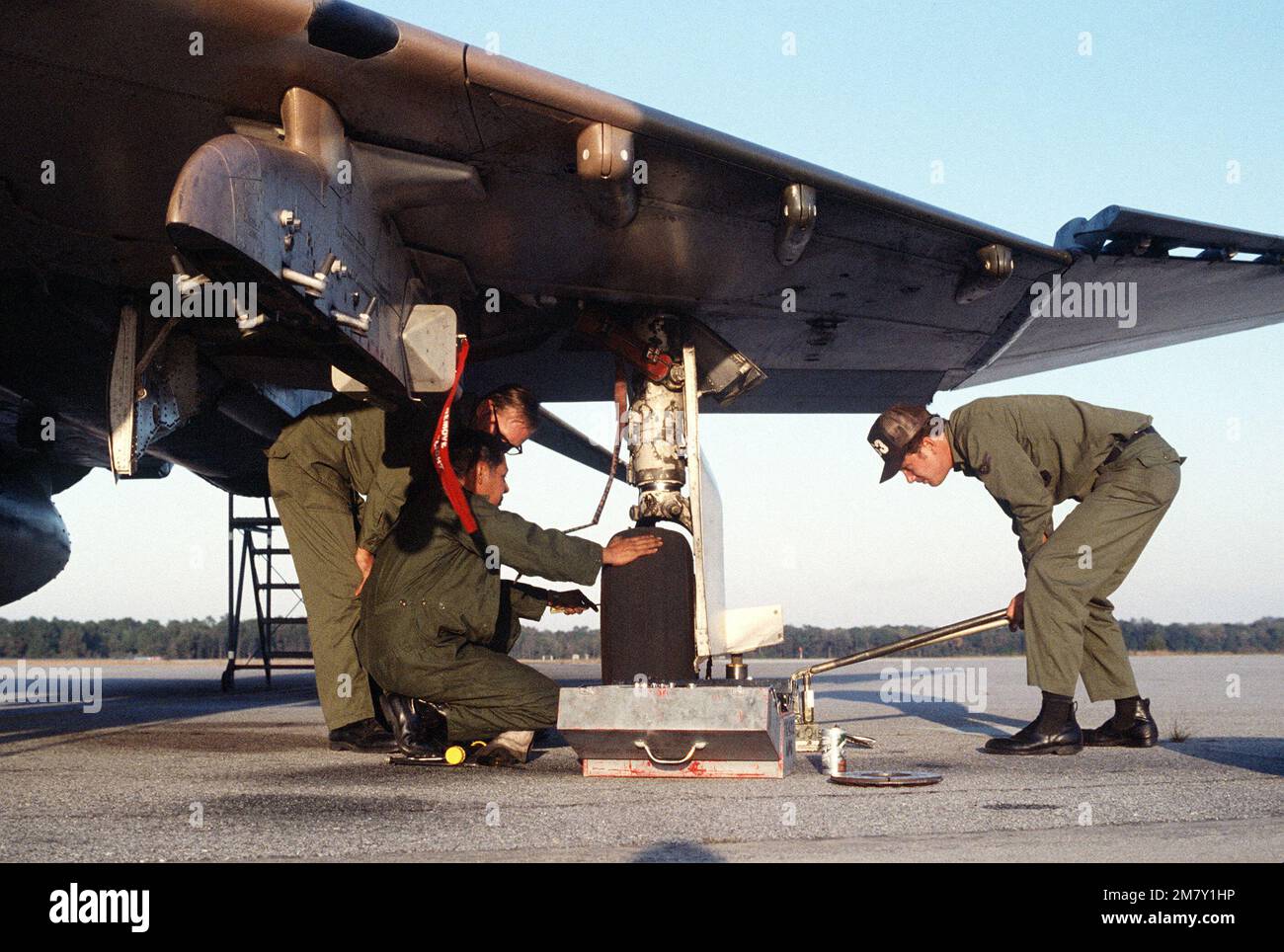 Members of the 563rd Tactical Fighter Squadron change a tire on an F-4 ...