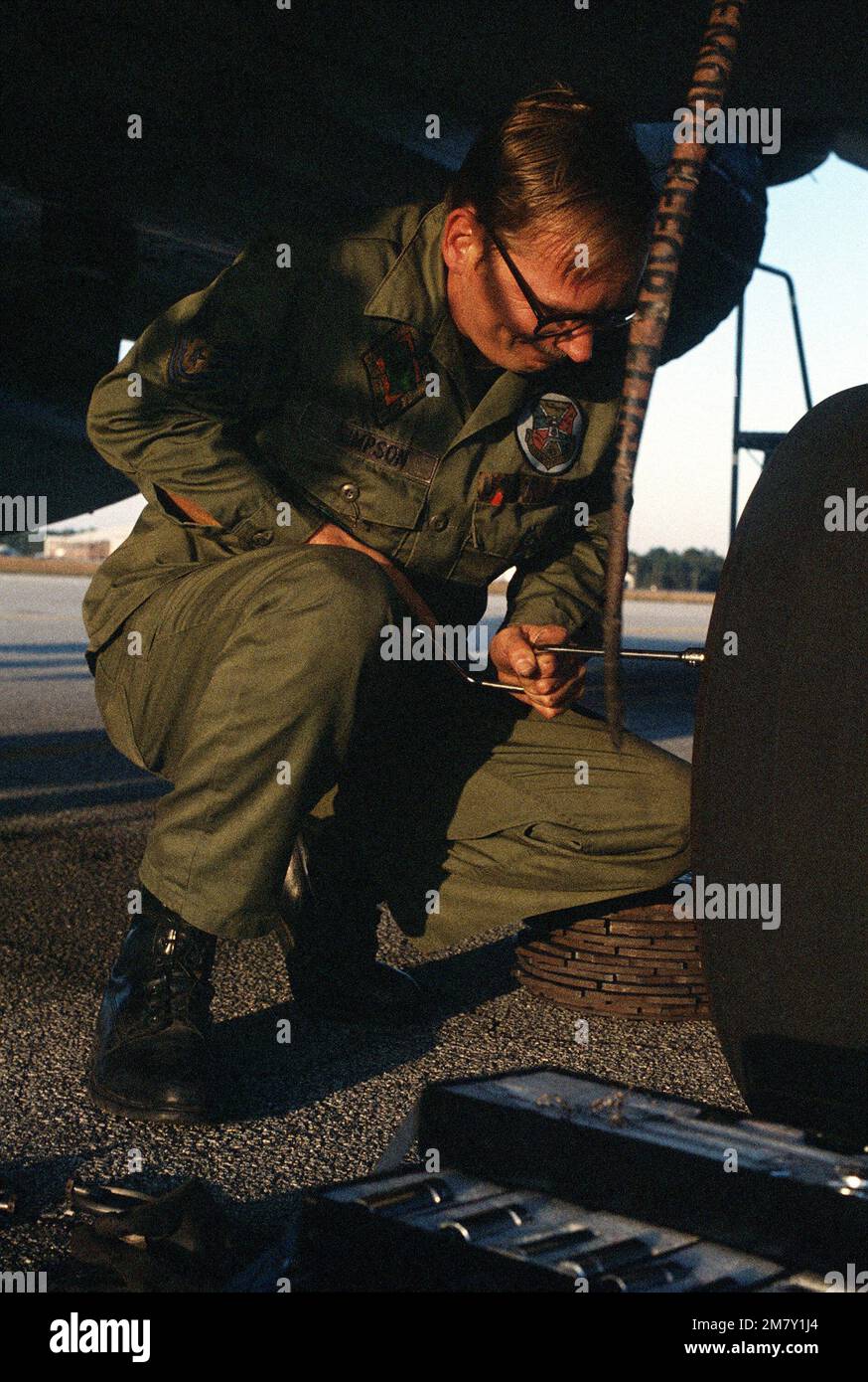 TSGT Morris Simpson of the 563rd Tactical Fighter Squadron changes a ...