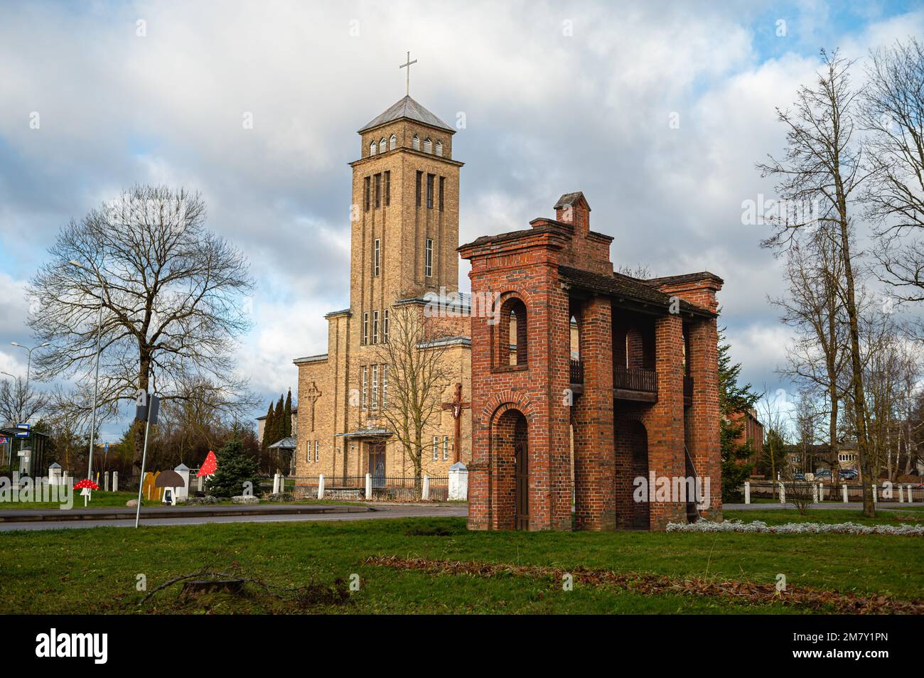 Old Catholic Church and red brick gates in city Akniste, Latvia ...