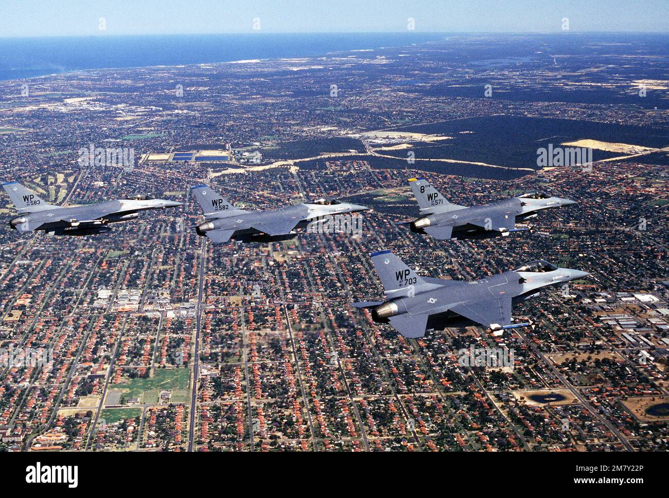 A right side view of a four-ship wedge formation of F-16 Fighting ...