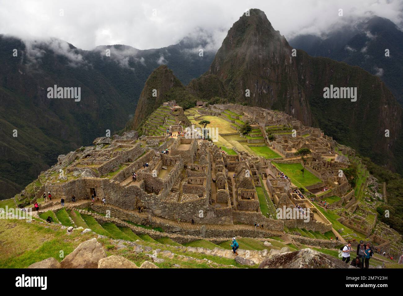 A women take a picture in Machu Picchu. Spiritual morning mist rises ...