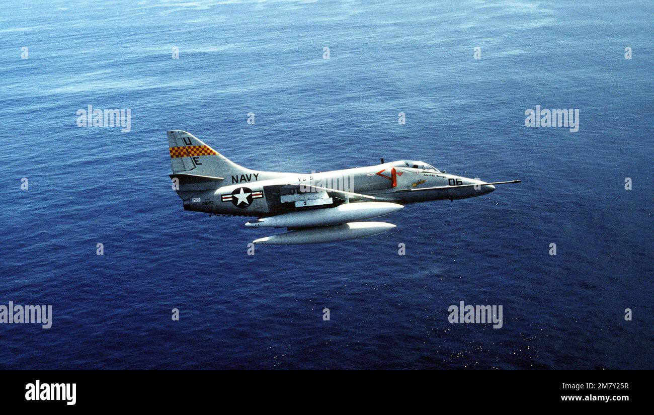 A right side view of a Navy A-4 Skyhawk aircraft banking to the left ...