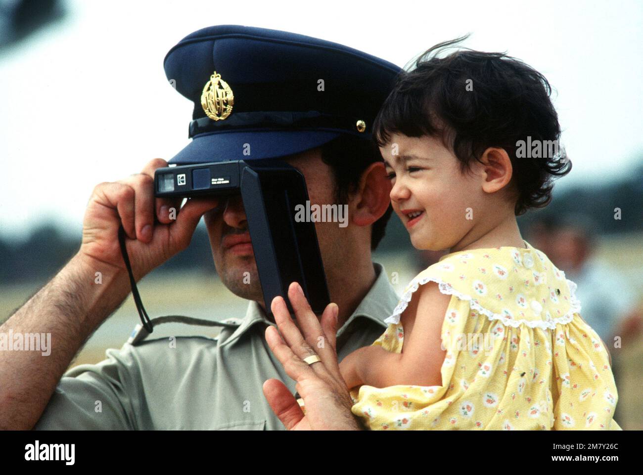 A Royal Australian Air Force member and his child watch an Exercise ...
