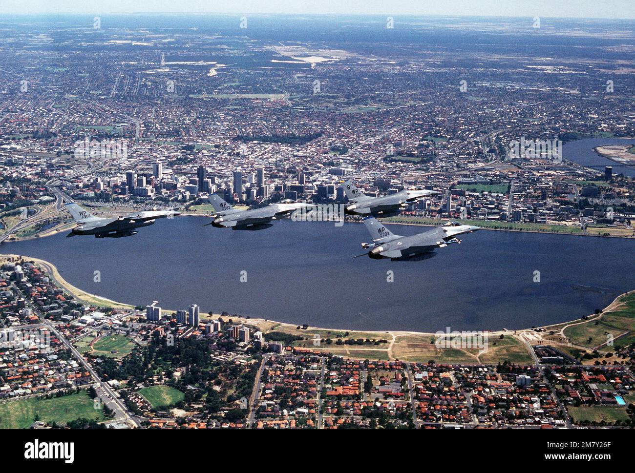A right side view of a four-ship wedge formation of F-16 Fighting ...