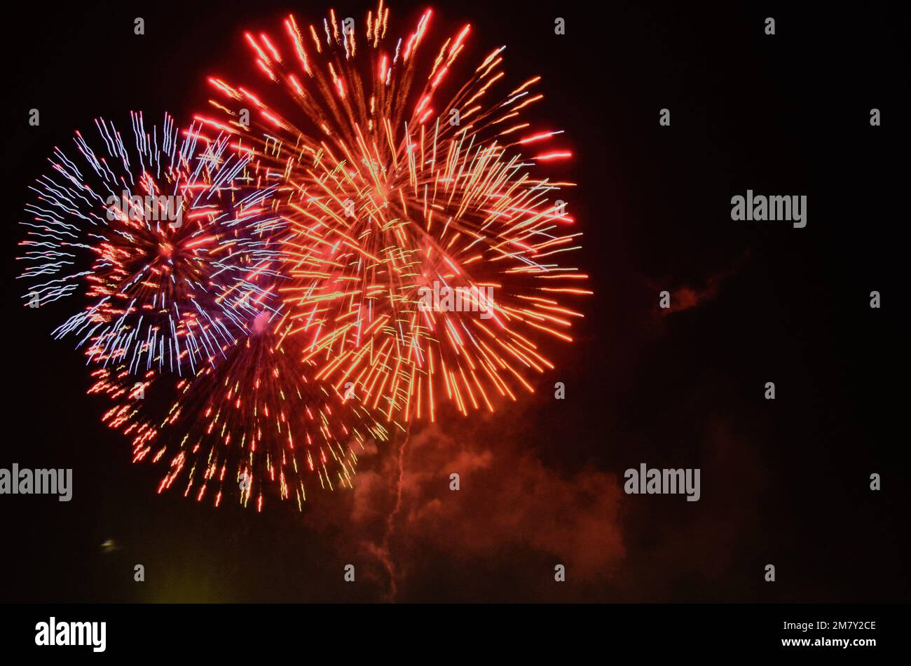 Bright fireworks lit up in the night sky Stock Photo - Alamy
