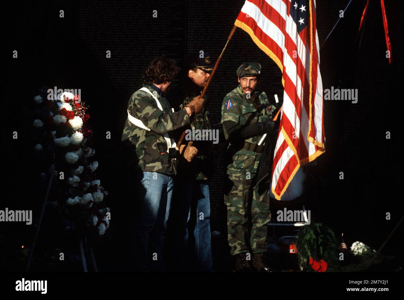 Veterans display an American flag and a POW-MIA flag during the ...