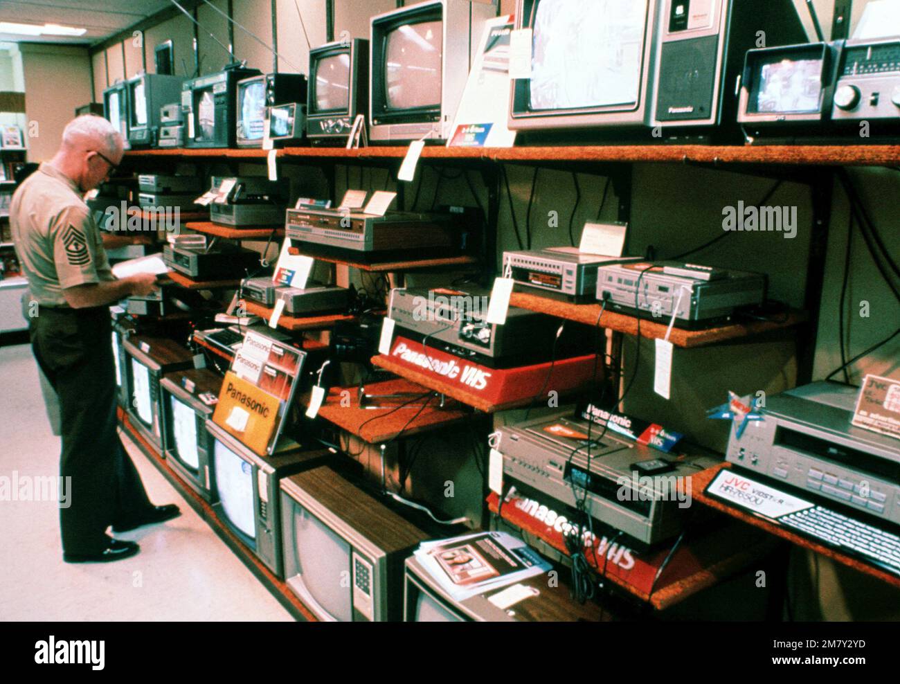 A Marine examines video equipment at the Camp Butler exchange. Base ...