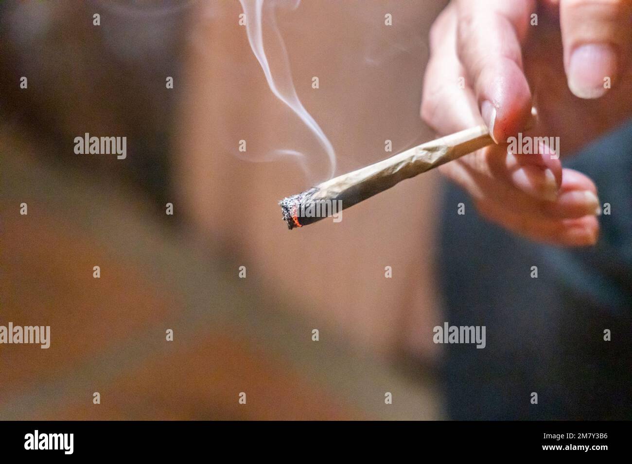 Cannabis joint holding smoke hi-res stock photography and images - Alamy
