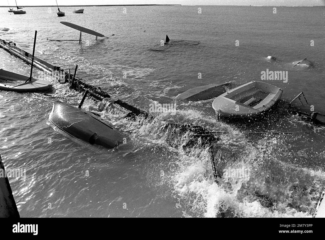 A view of a dock that was destroyed and several small boats that were ...