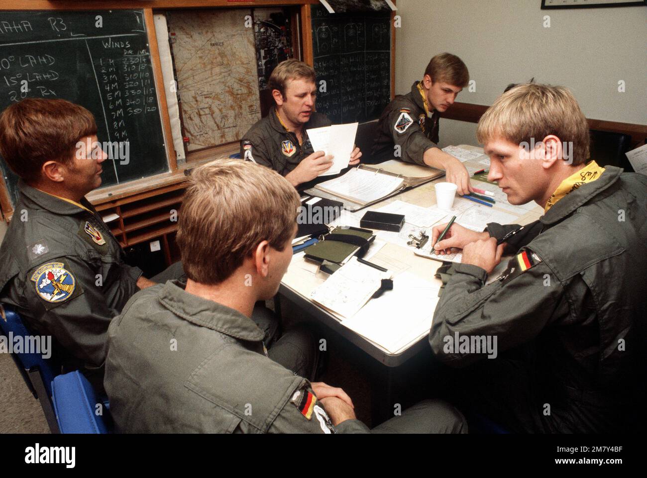 German military pilots are briefed by members of the 69th Tactical ...