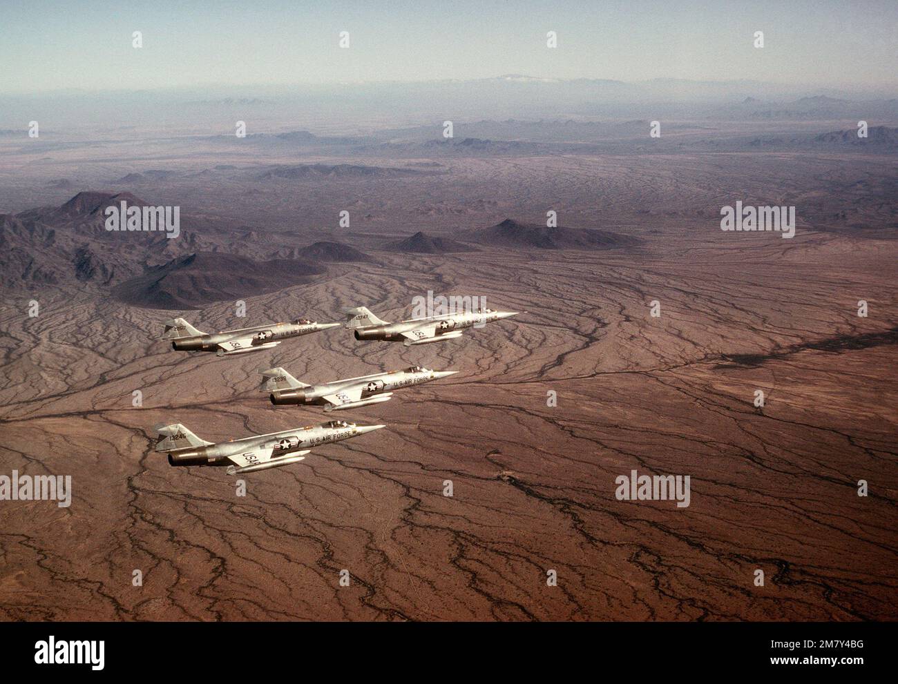 An air-to-air right side view of four F-104G Starfighter aircraft ...