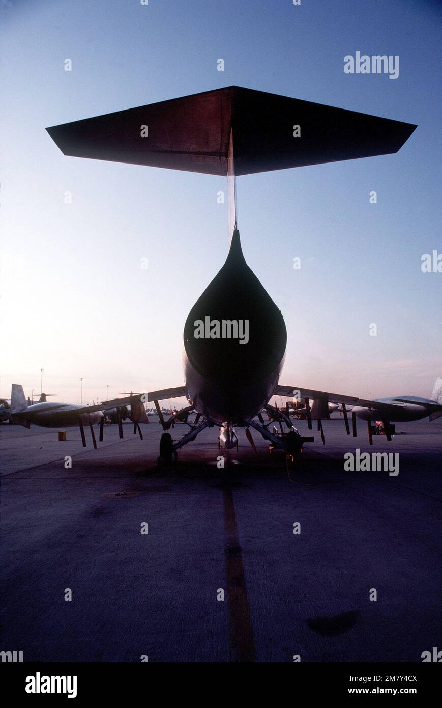 A rear silhouetted view of F-104G Starfighter aircraft parked on the ...