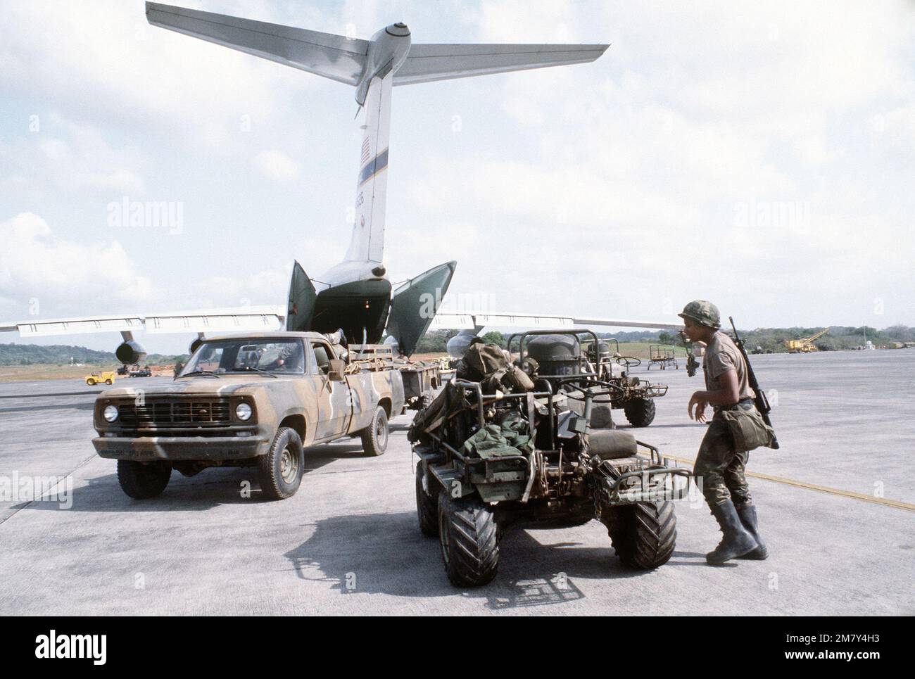 An M274 (4 X 4) mechanical mule vehicle (right) is examined after being ...