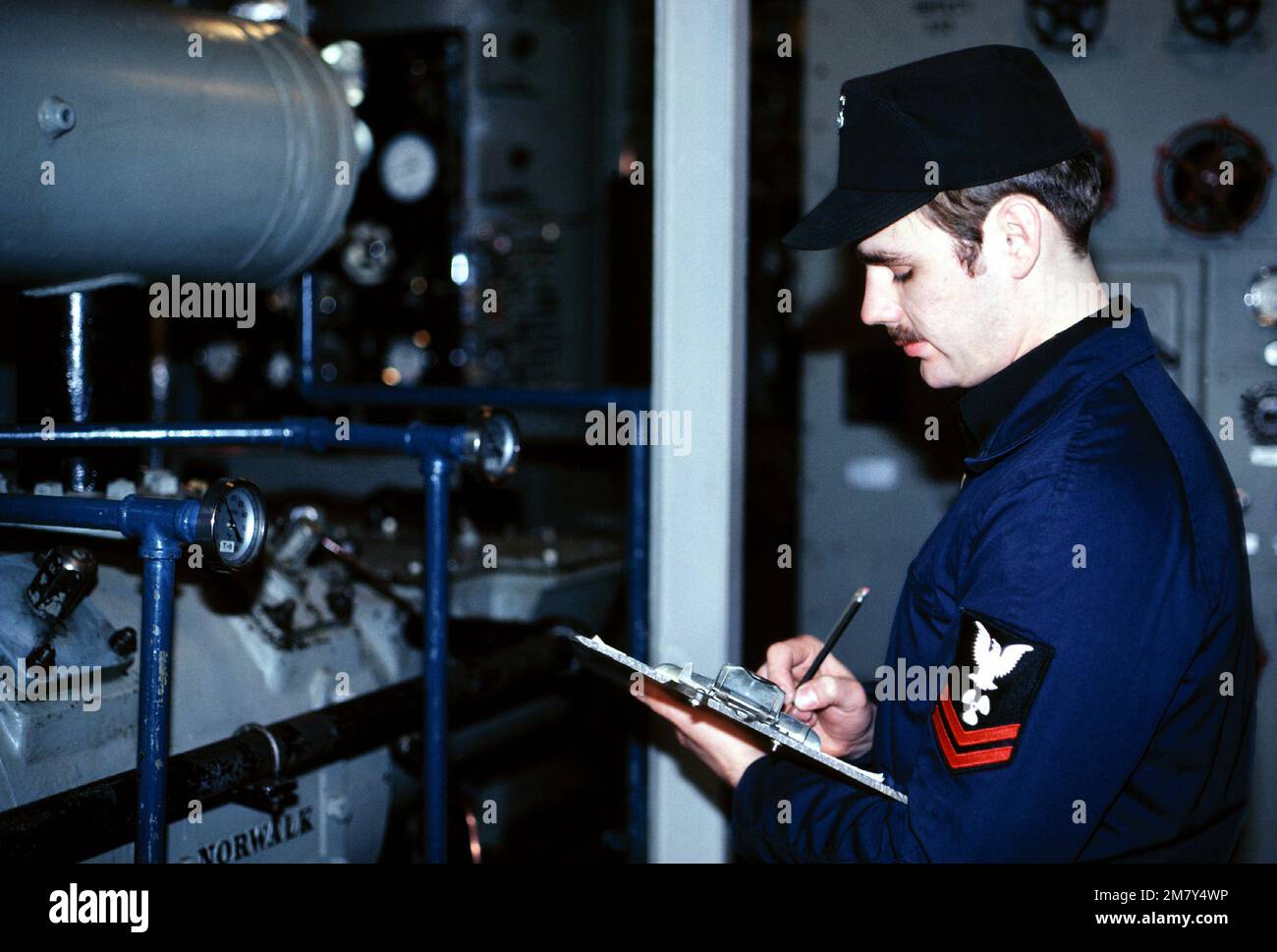 Machinist's Mate Christopher Mudy performs assigned duties in the ...