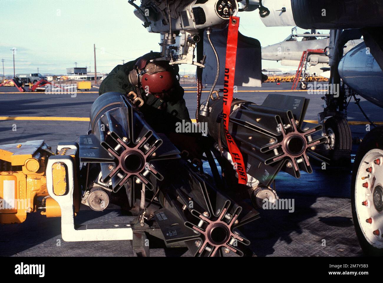 A crewman uploads three Mark 81 general purpose high explosive bombs ...