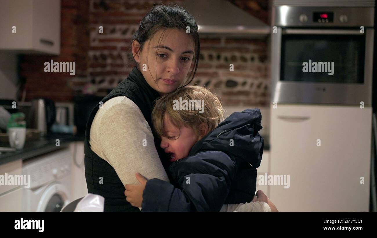 Mother consoling tearful crying baby toddler boy, casual and candid ...