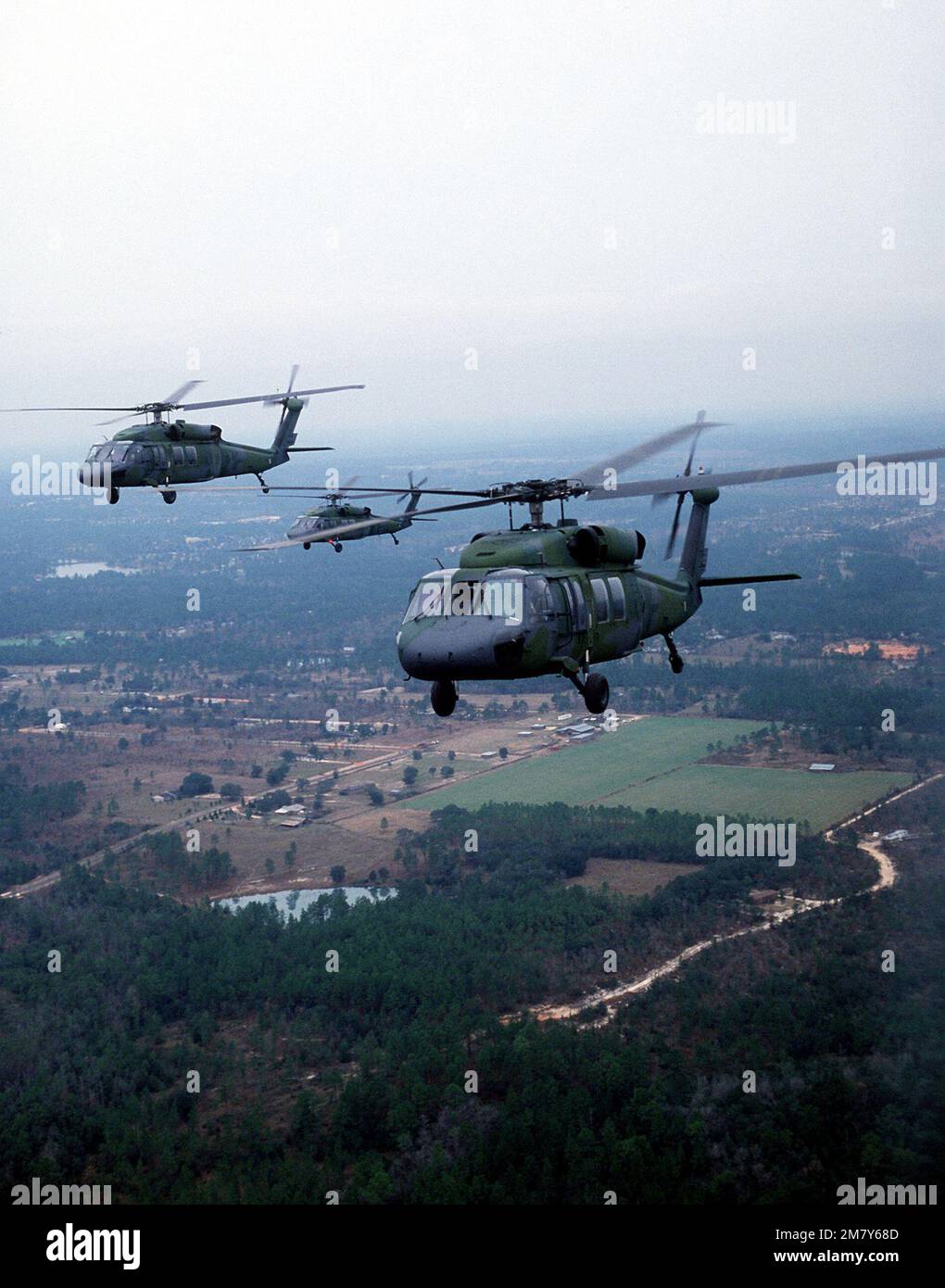 Left side air-to-air view of three UH-60A Black Hawk helicopters en ...