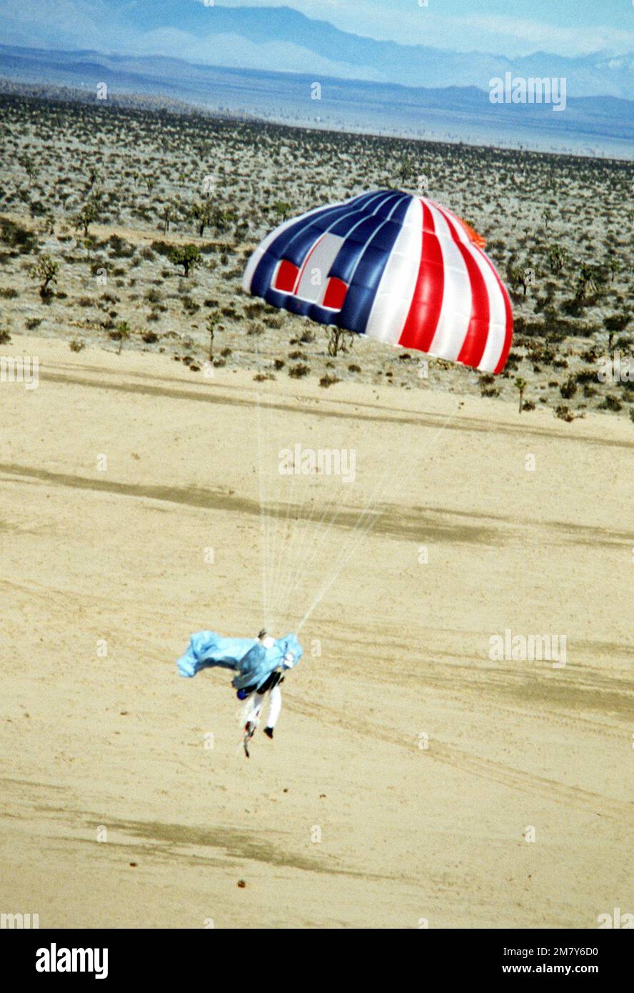 A member of the parachute-test team descends toward his target at the ...