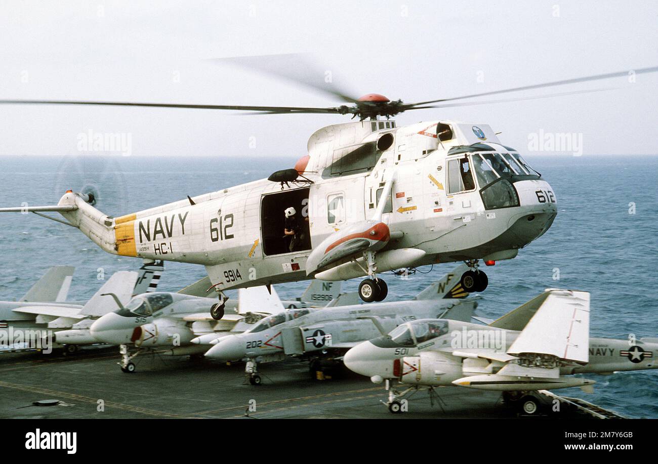 A right side view of a U.S. Navy SH-3 Sea King helicopter as it hovers ...