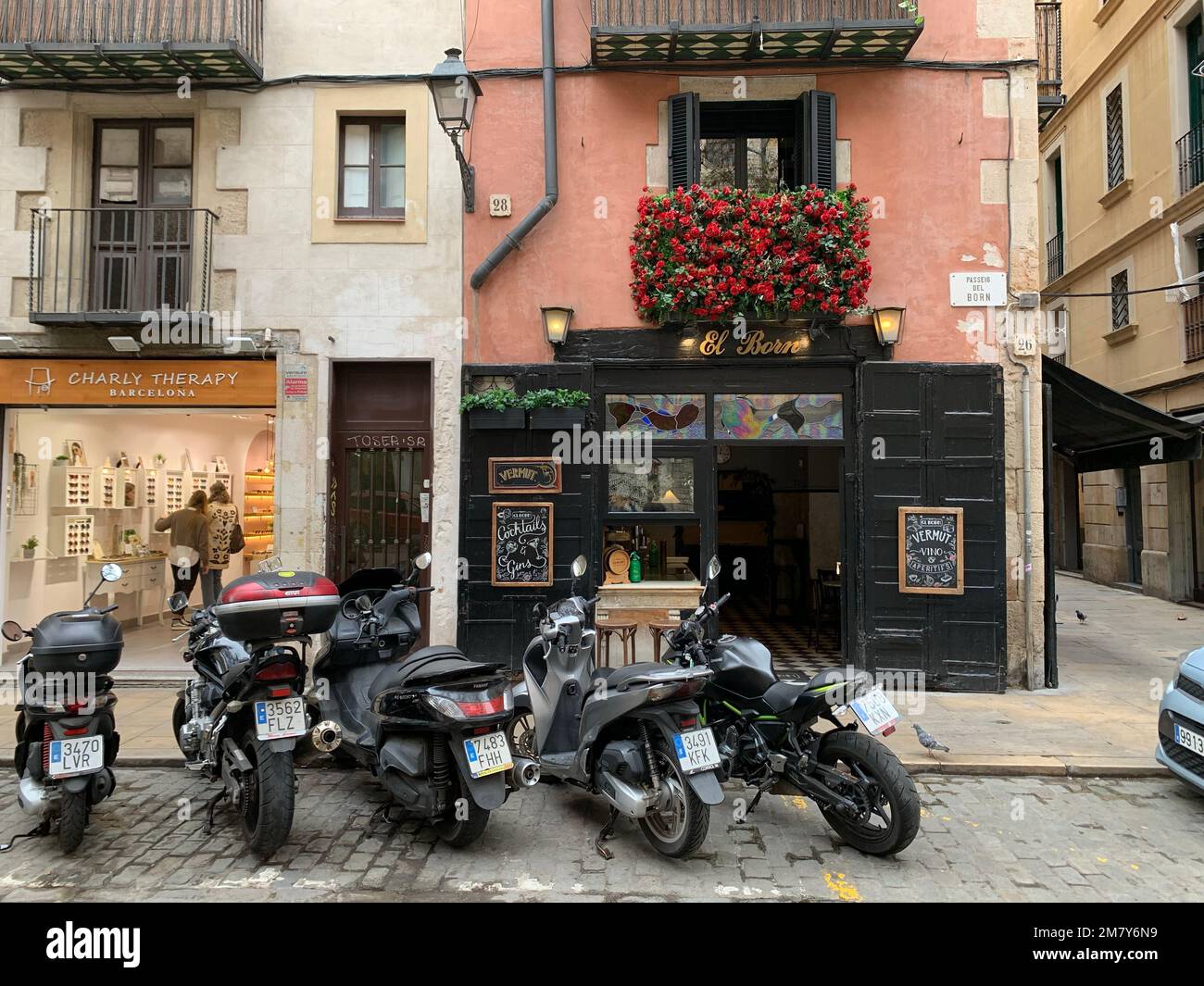 Red roses above a shop on a busy street in Barcelona Stock Photo - Alamy