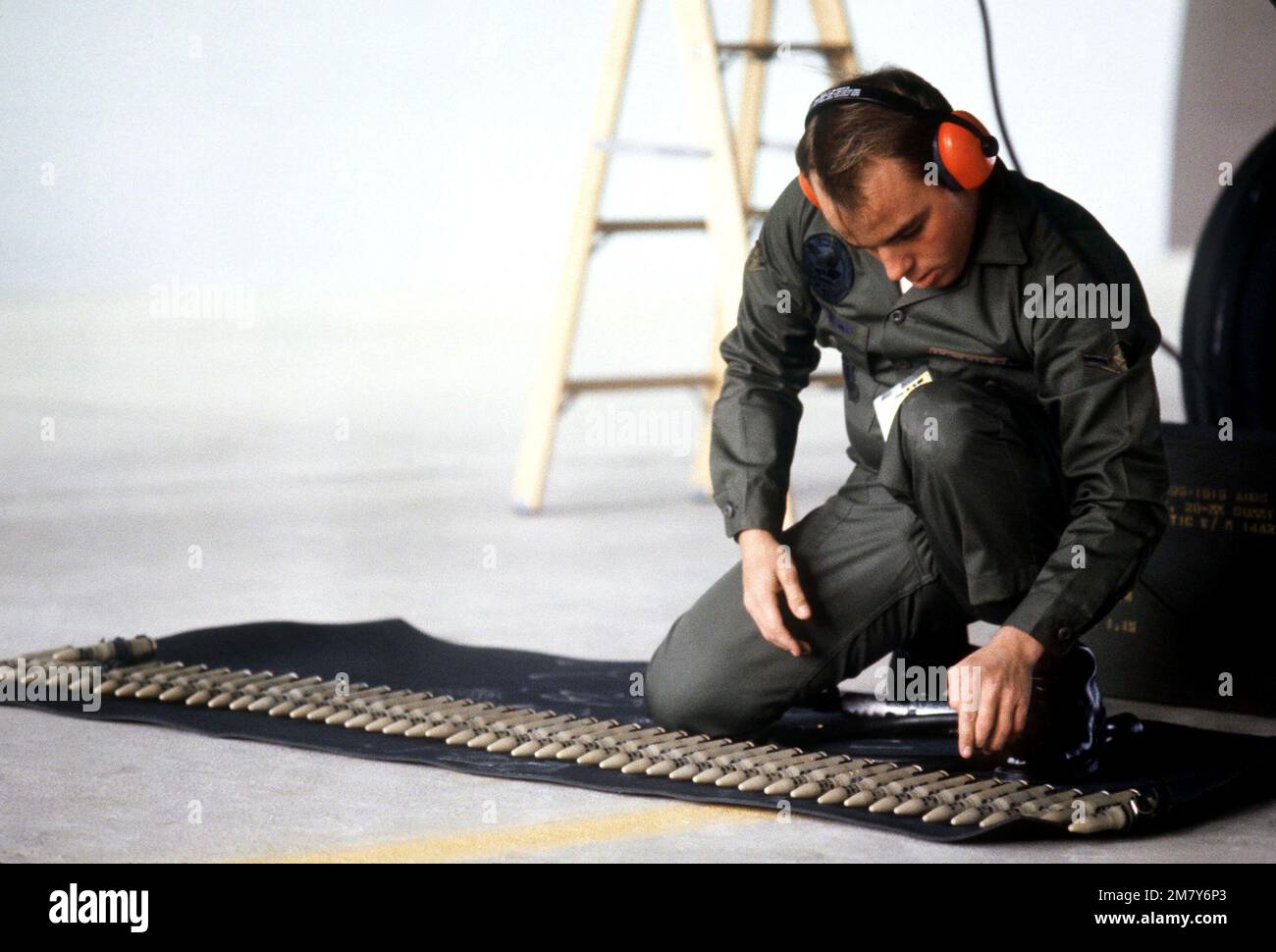 AMN Andrew Jennings checks 20mm shells prior to loading them on an F-15 ...