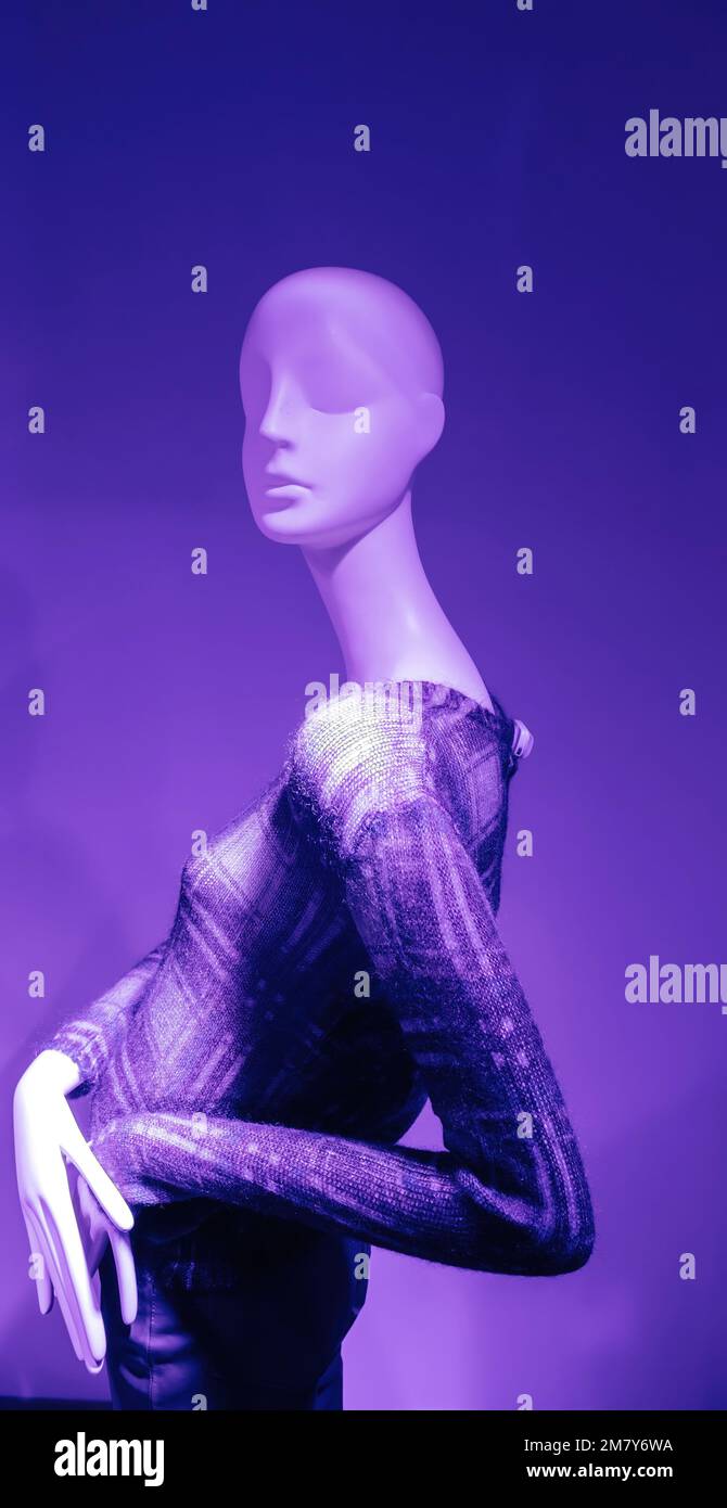 Mannequin wearing a luxury wool dress seen through the window ...