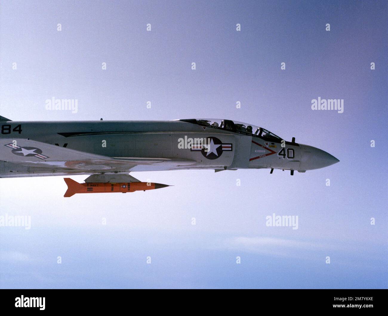 An air-to-air right front view of an F-4 Phantom II aircraft, with an ...