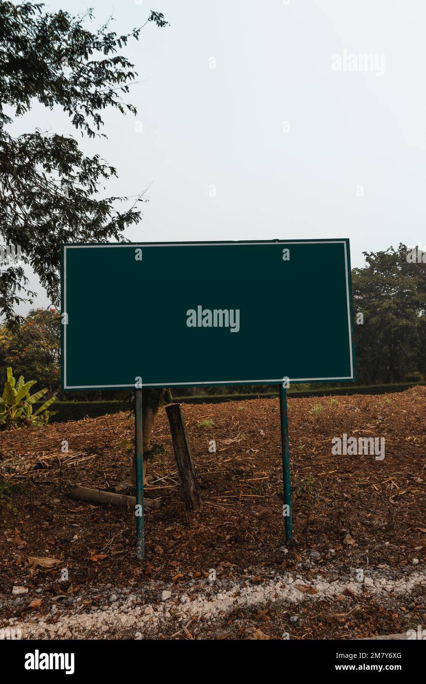 Empty green sign, roadside in Northern Thailand countryside. With ...