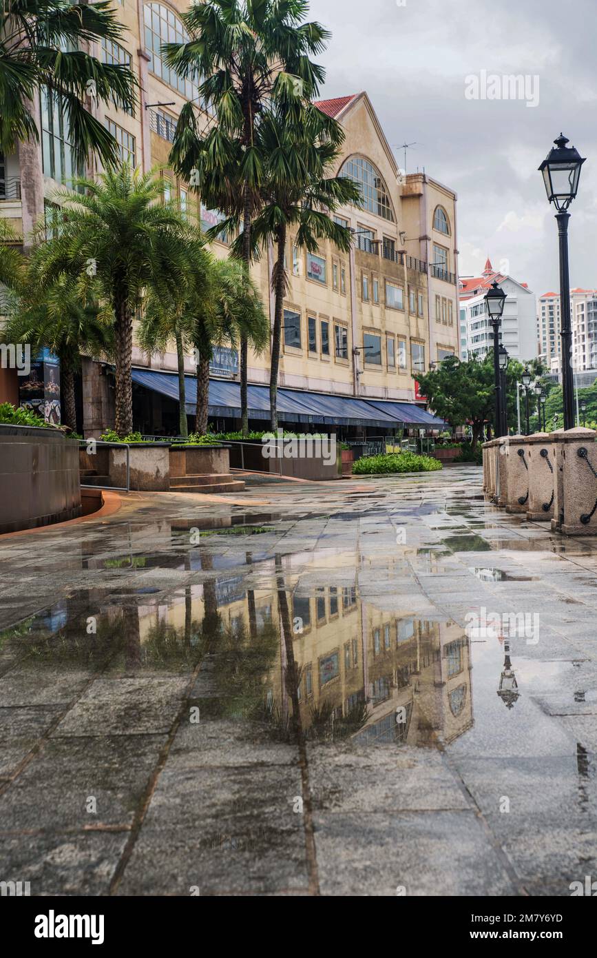 Riverside Point, Clarke Quay reflected in puddles after a rainstorm in ...