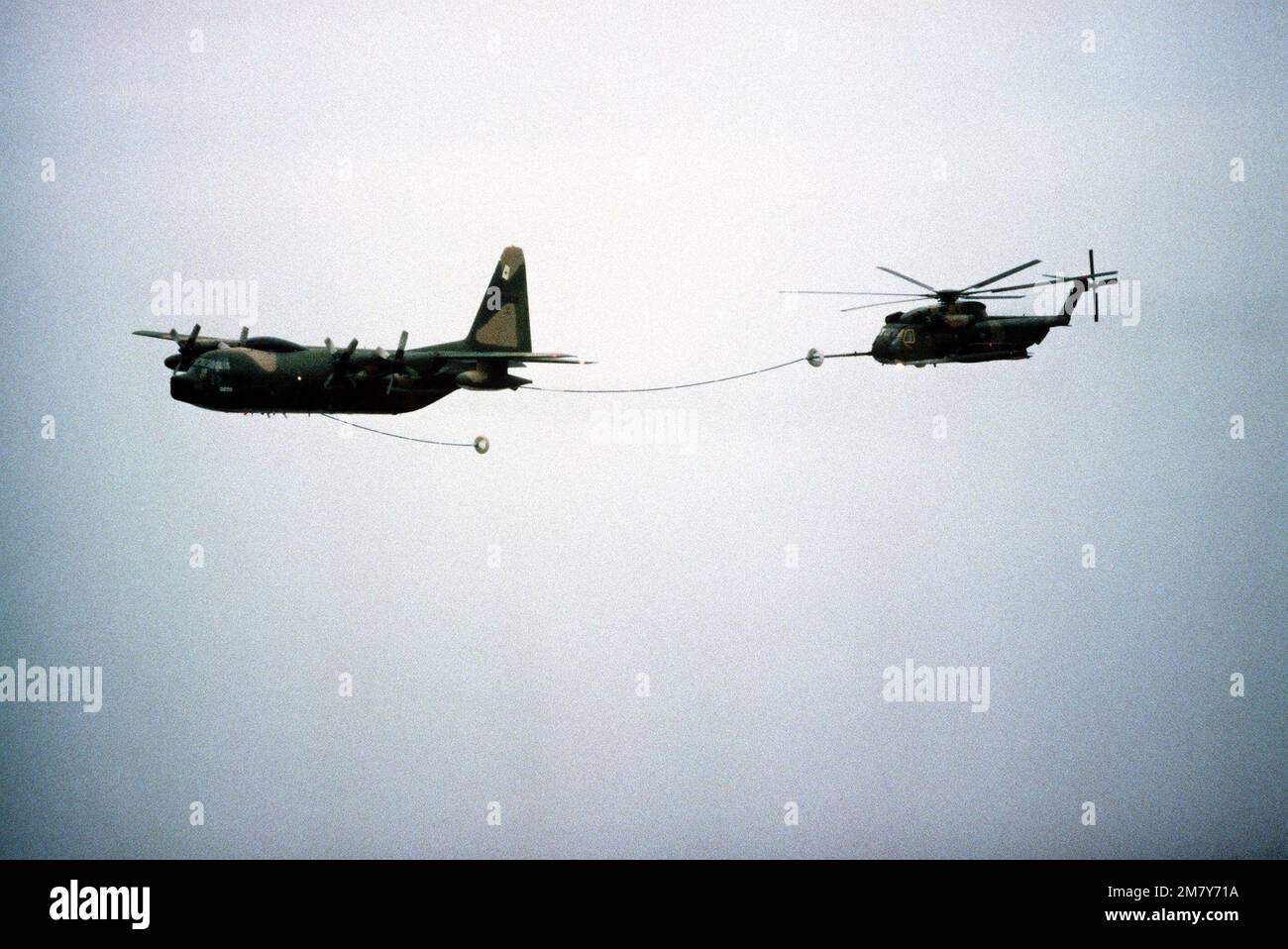 A front view of an HC-130P Hercules aircraft refueling an HH-53 Super ...