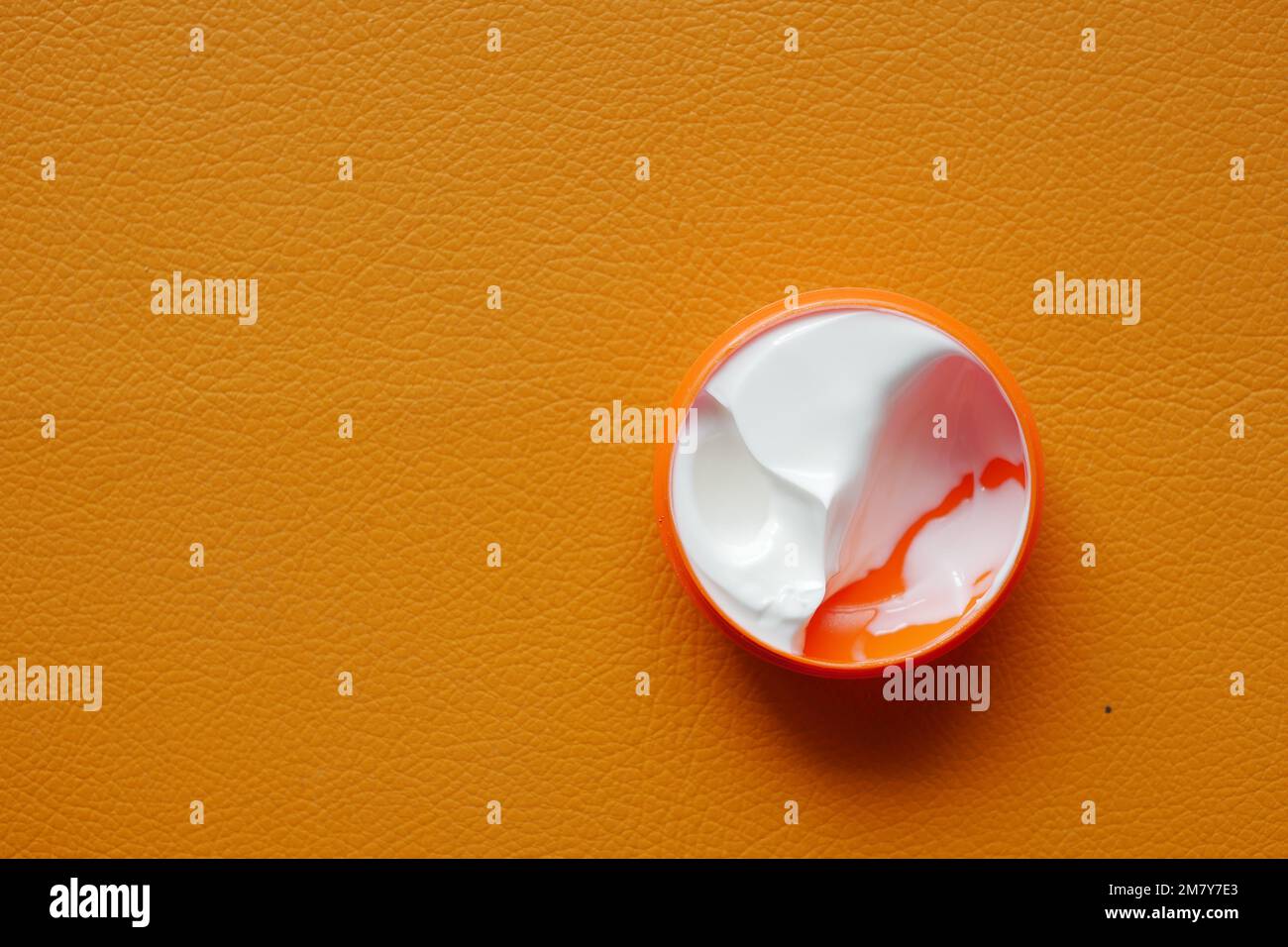 beauty cream in a orange color container Stock Photo - Alamy