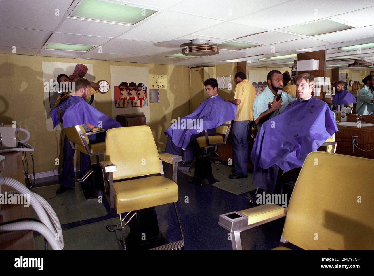 Crewmen get haircuts in the barber shop aboard the nuclear-powered ...