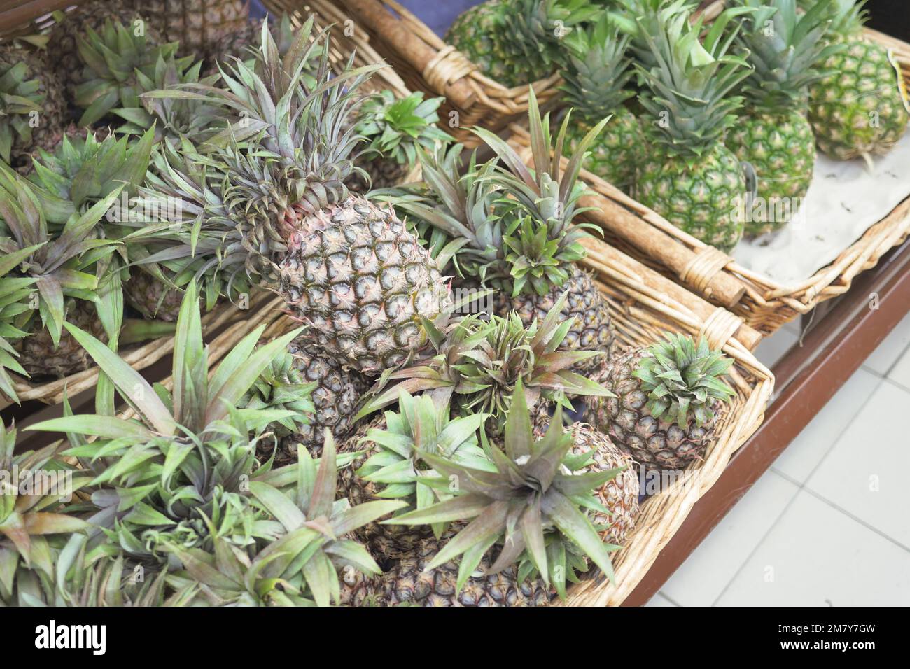 pineapple display for sale at local store Stock Photo - Alamy