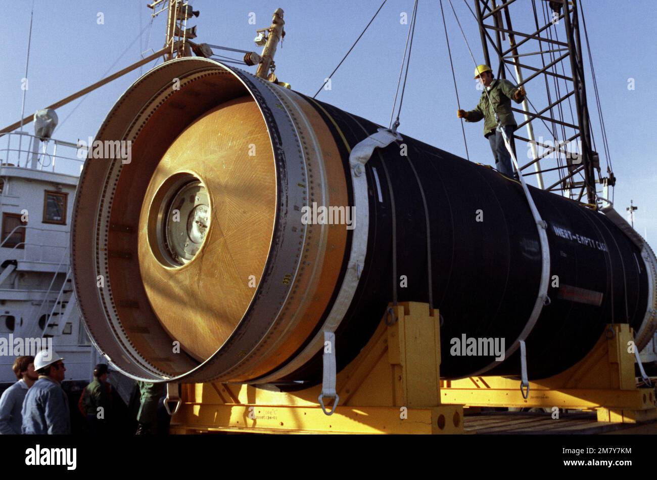 An empty first stage MX missile booster is prepared for loading aboard ...