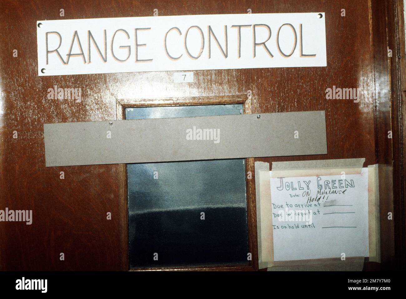 A sign on the door indicating the entrance to the range control room in ...