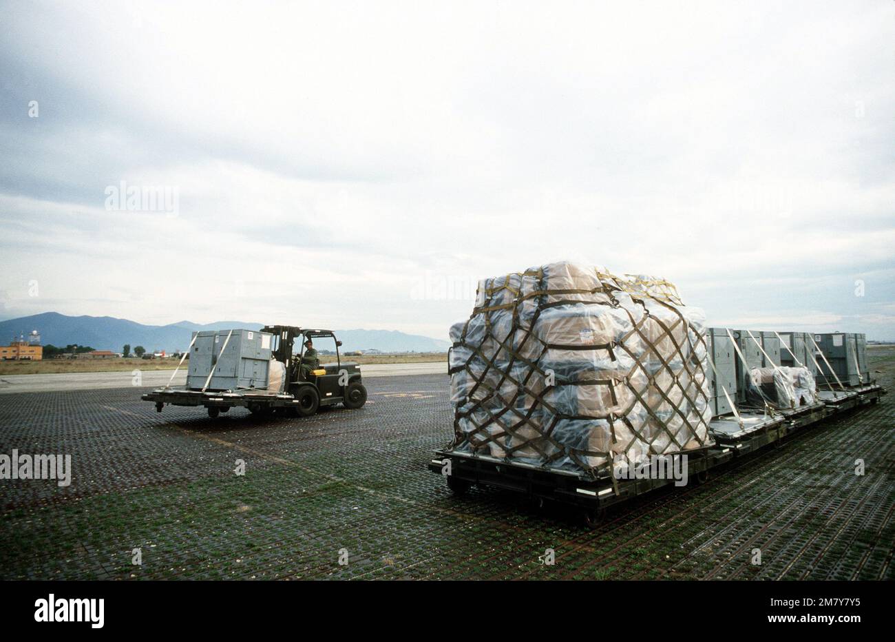 SSGT Guy James uses a forklift to move an electric power generator into ...