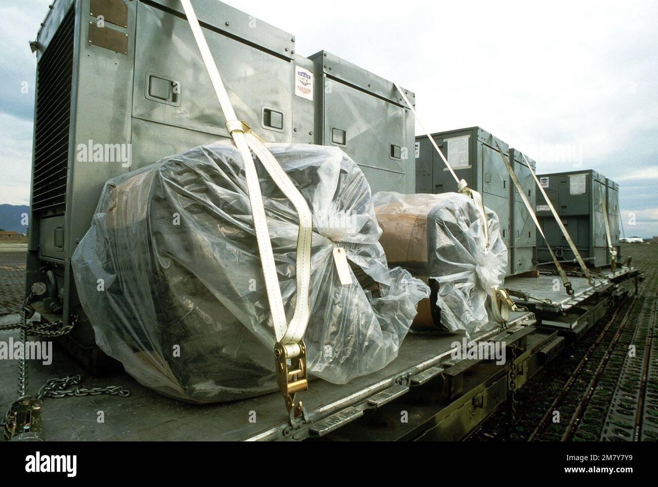 Electric power generators are in position to be loaded aboard a C-141B ...
