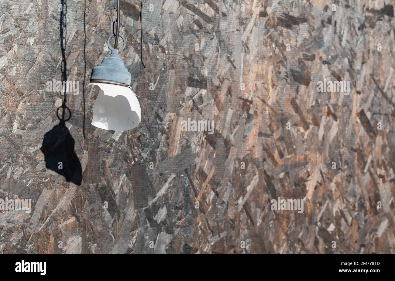 Broken lantern with shadow on textured wall in bright sunlight Stock ...