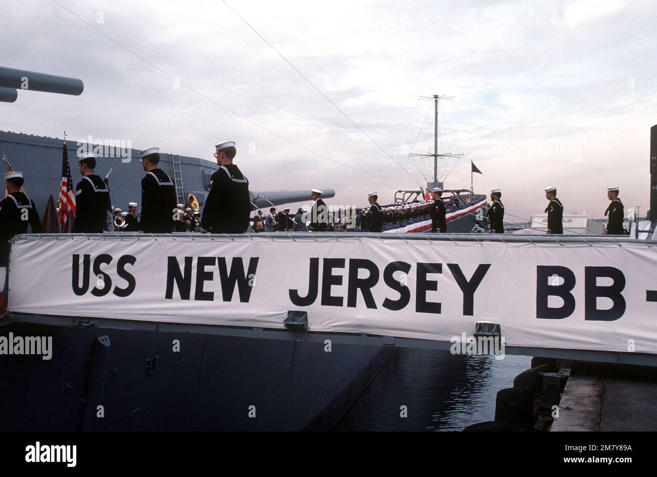 Crewmen file aboard the battleship USS NEW JERSEY (BB-62) during the ...