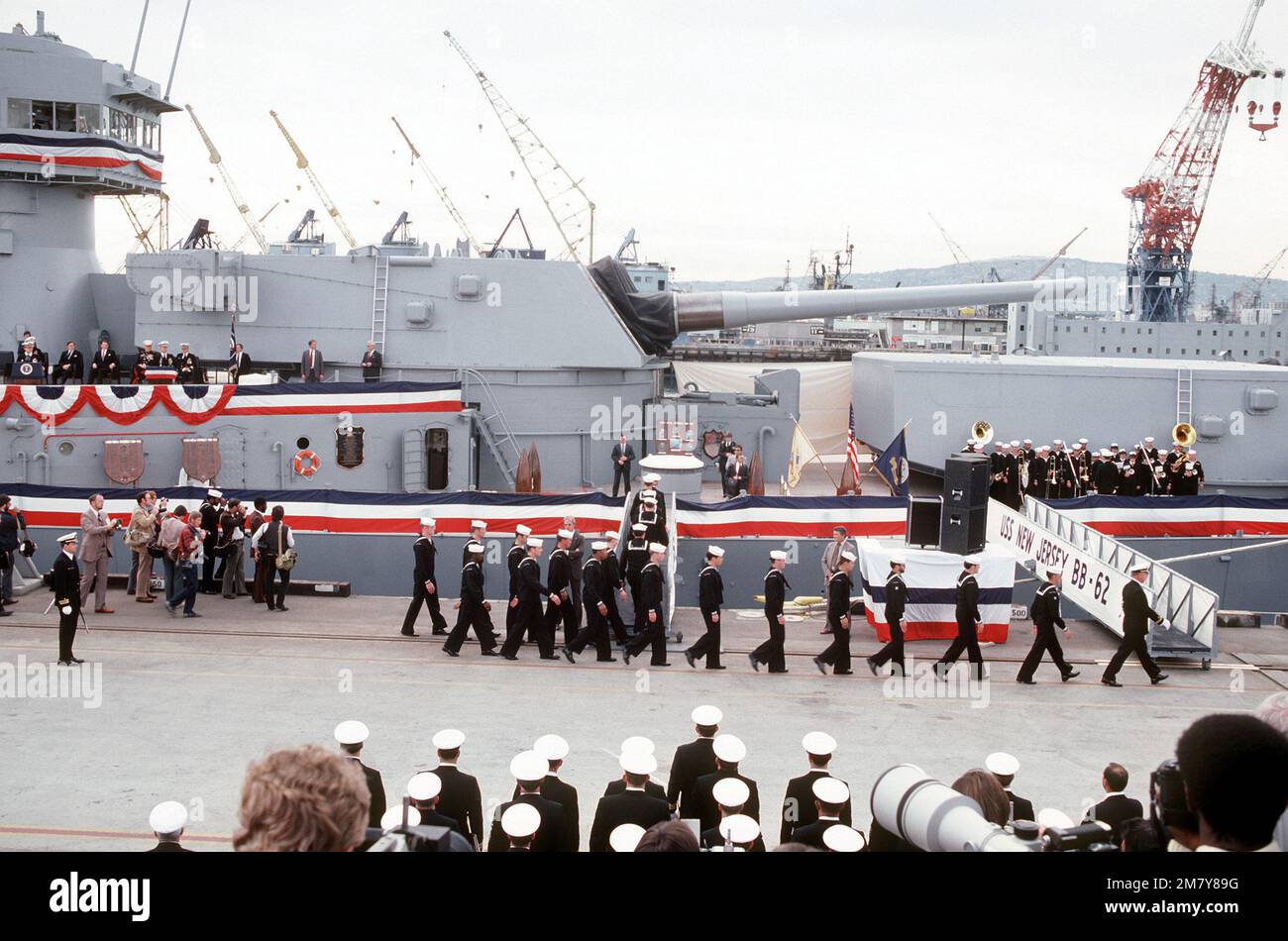 Crewmen file aboard the battleship USS NEW JERSEY (BB-62) during the ...