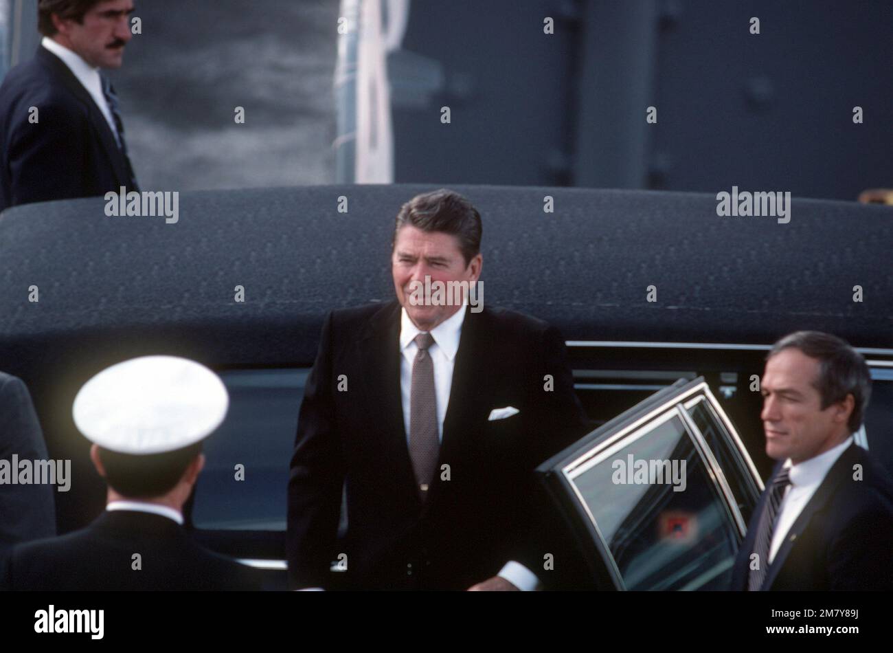 President Ronald Reagan steps from his limousine upon his arrival for ...