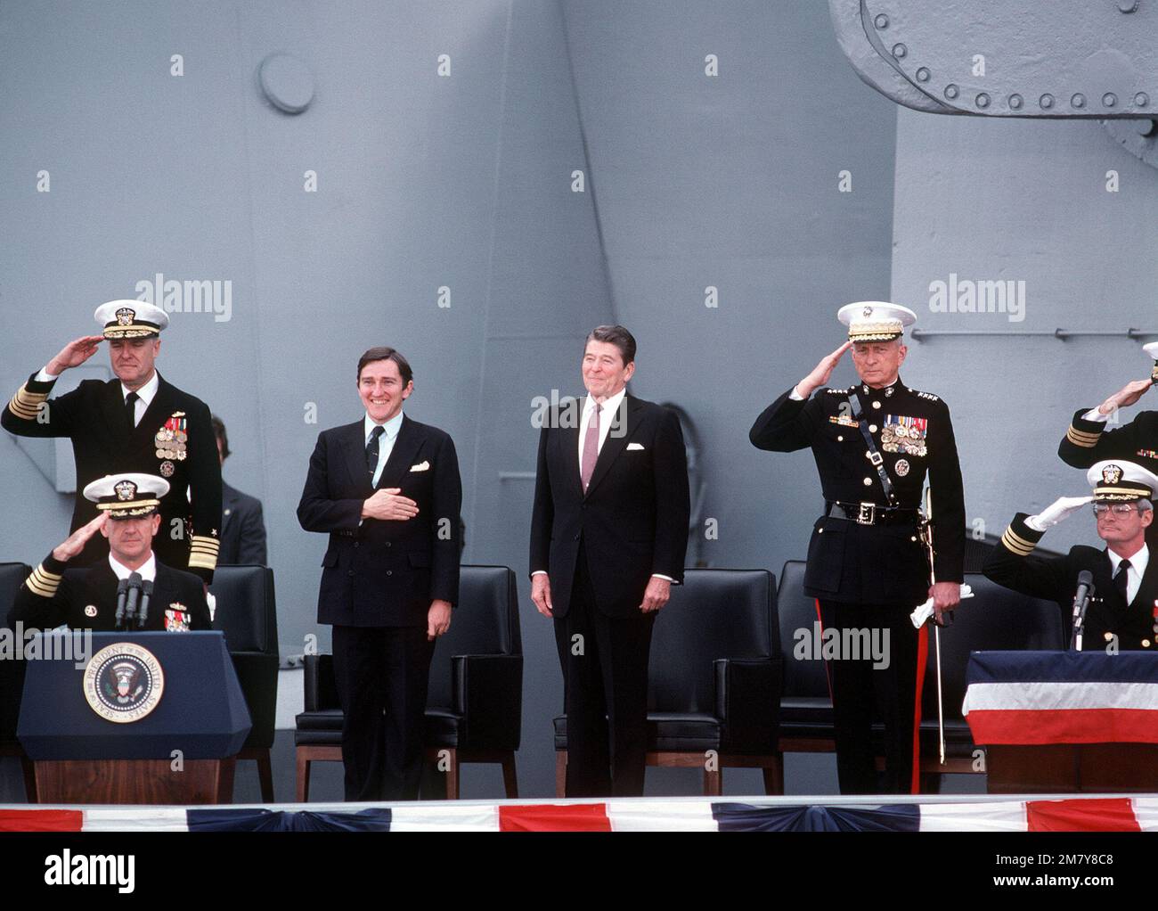 CAPT William M. Fogarty, commanding officer, salutes from behind the ...