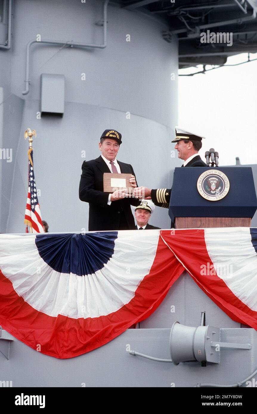 CAPT William M. Fogarty, commanding officer, presents a plaque ...