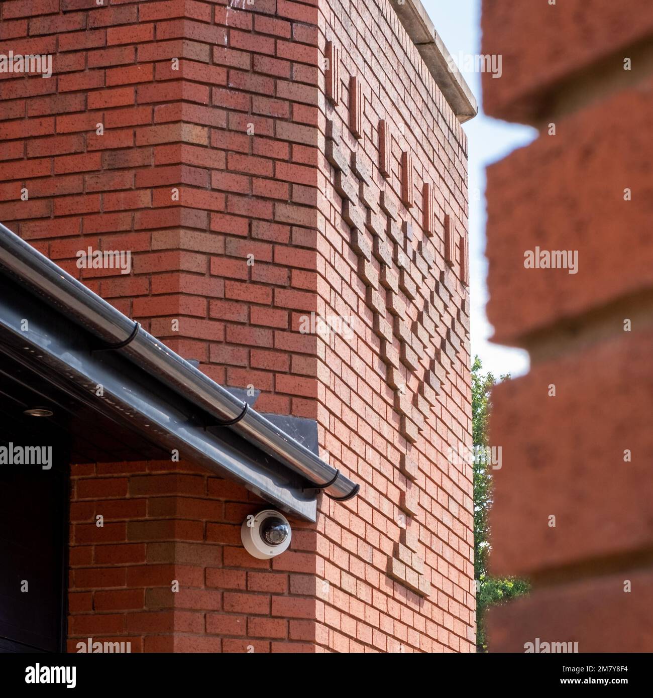 Pinner Synagogue in Cecil Park, built in red brick, with menorah icon ...