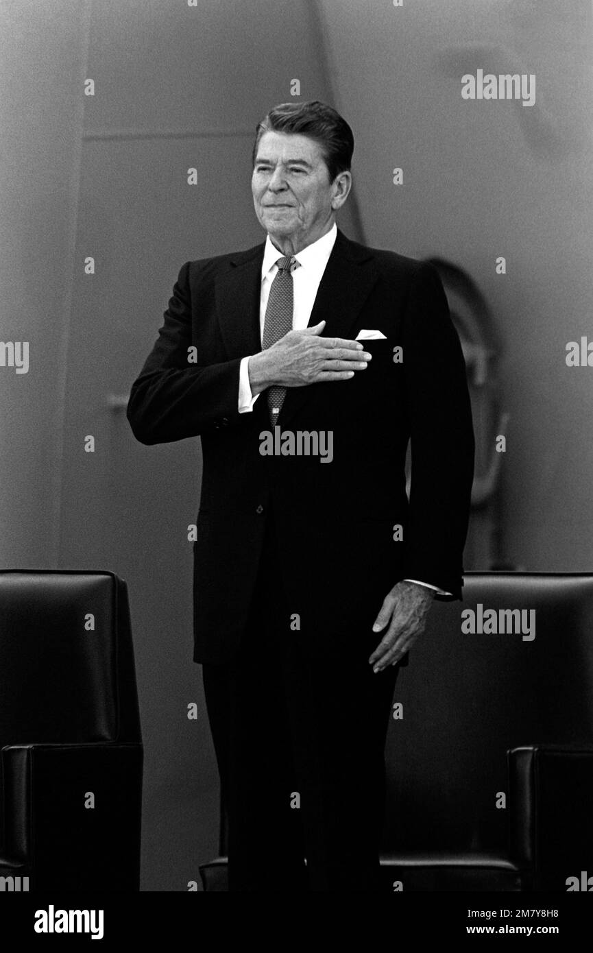 President Ronald Reagan stands as the national anthem is played during ...