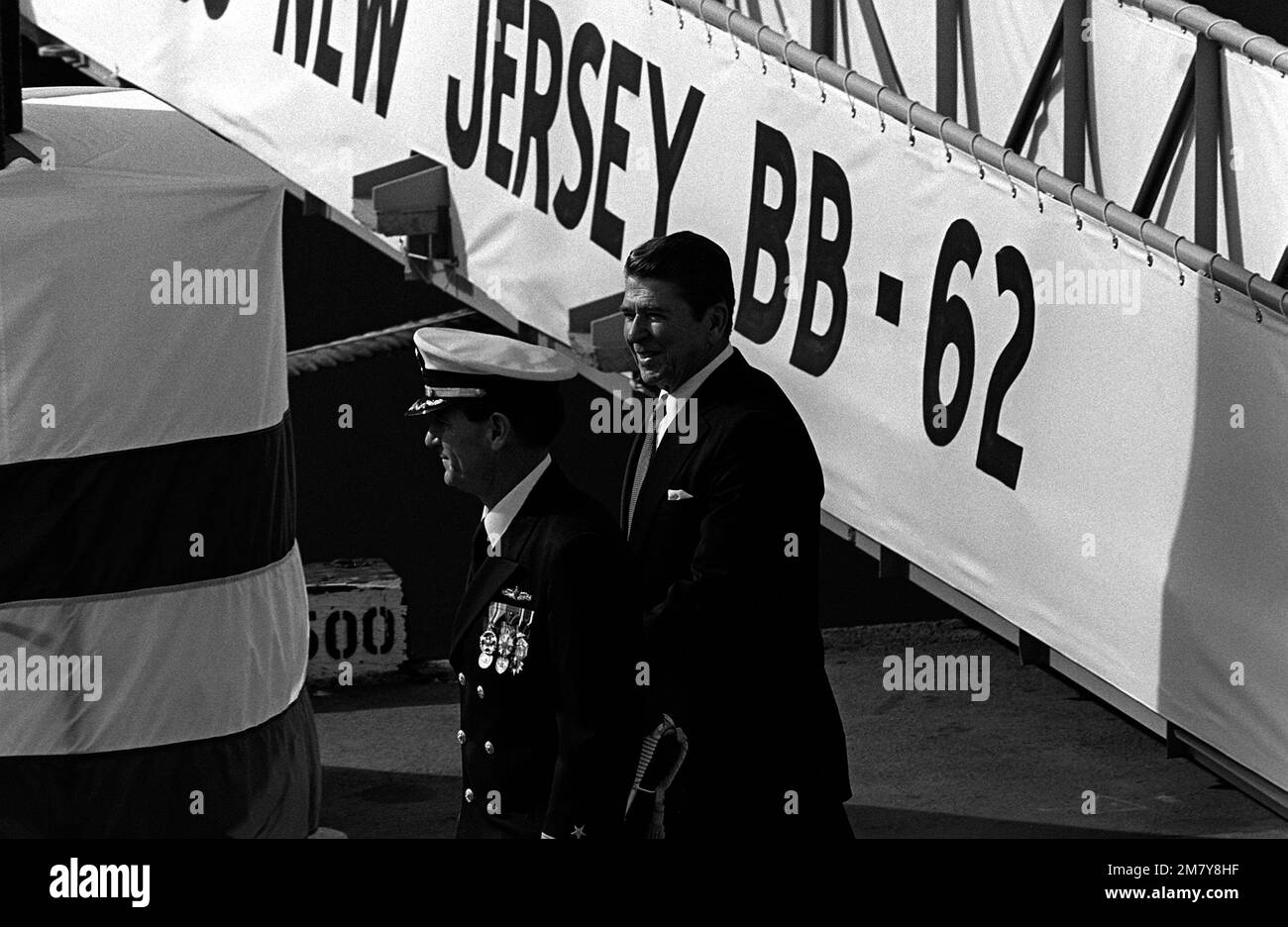 President Ronald Reagan walks with CAPT William M. Fogarty, commanding ...