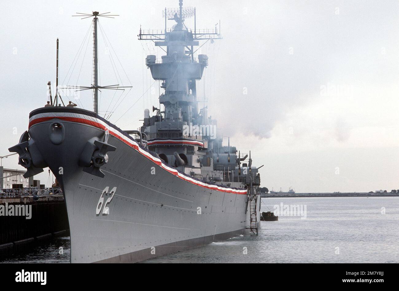 A port bow view of the battleship USS NEW JERSEY (BB-62), with bunting ...