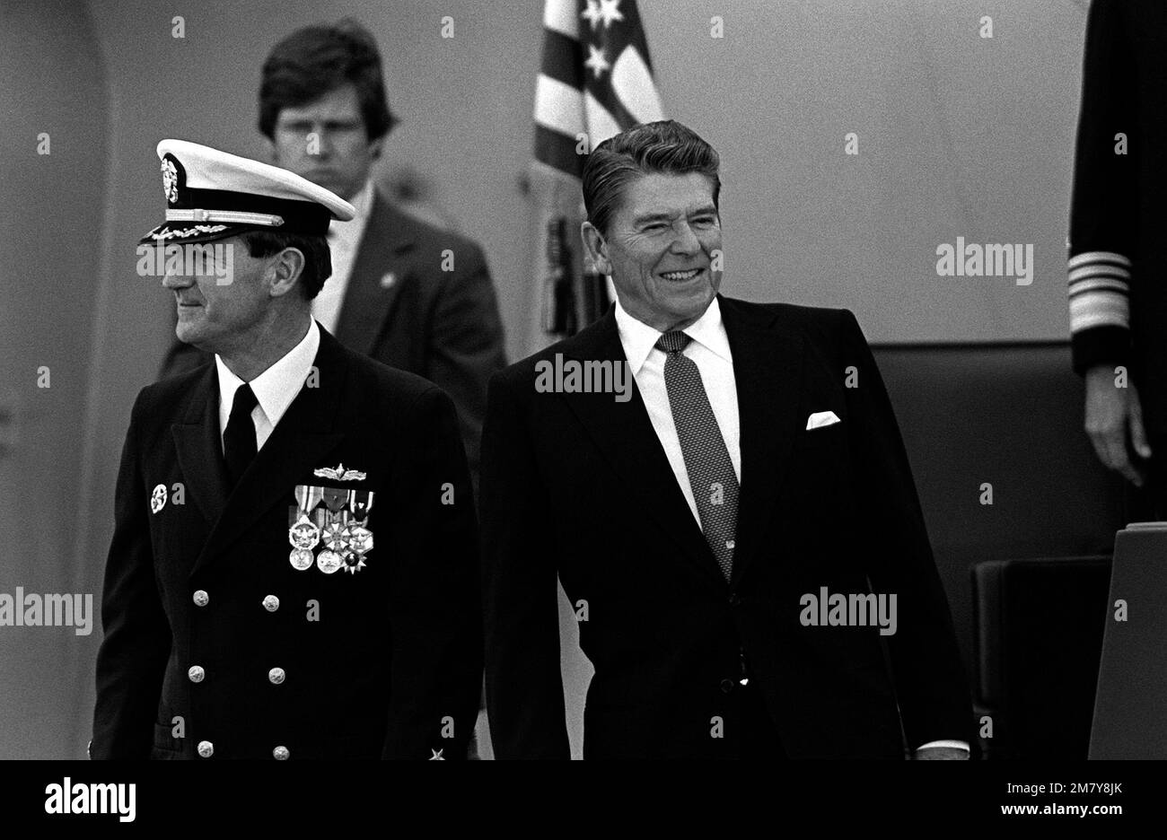 President Ronald Reagan stands beside CAPT William M. Fogarty ...